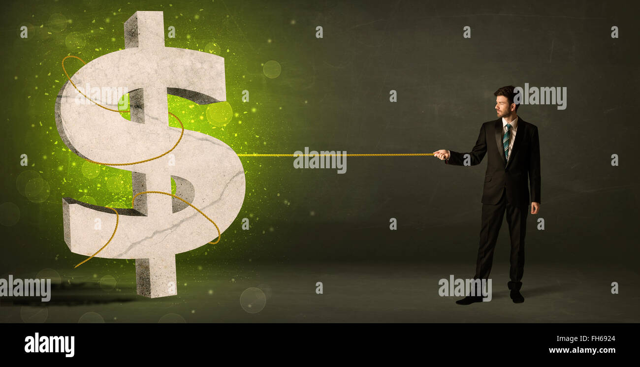 Business man pulling a big green dollar sign Stock Photo - Alamy