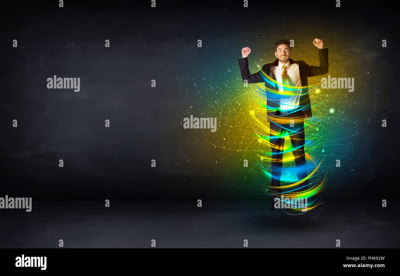 Excited business man jumping with energy colourful lines Stock Photo ...
