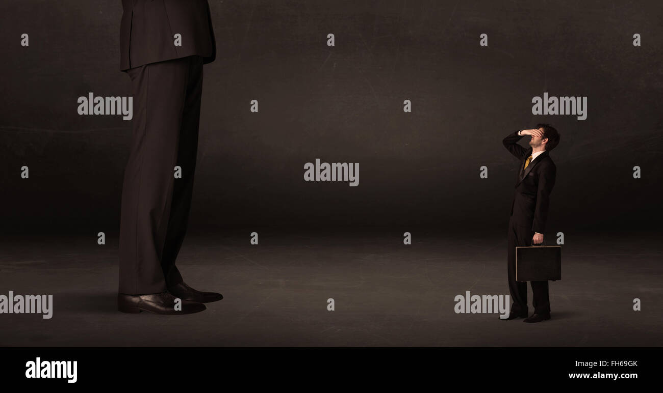 Huge man with small businessman standing at front concept Stock Photo ...