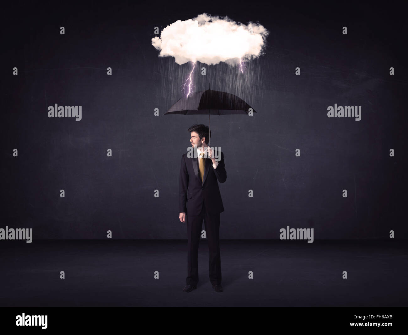 Businessman standing with umbrella and little storm cloud Stock Photo ...