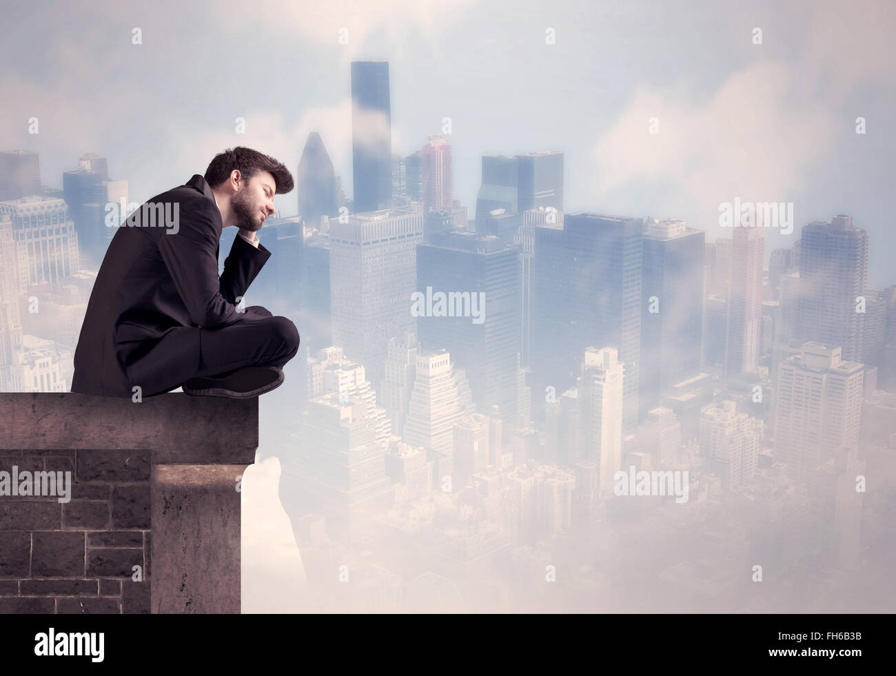 Sales person sitting on top of a tall building Stock Photo - Alamy