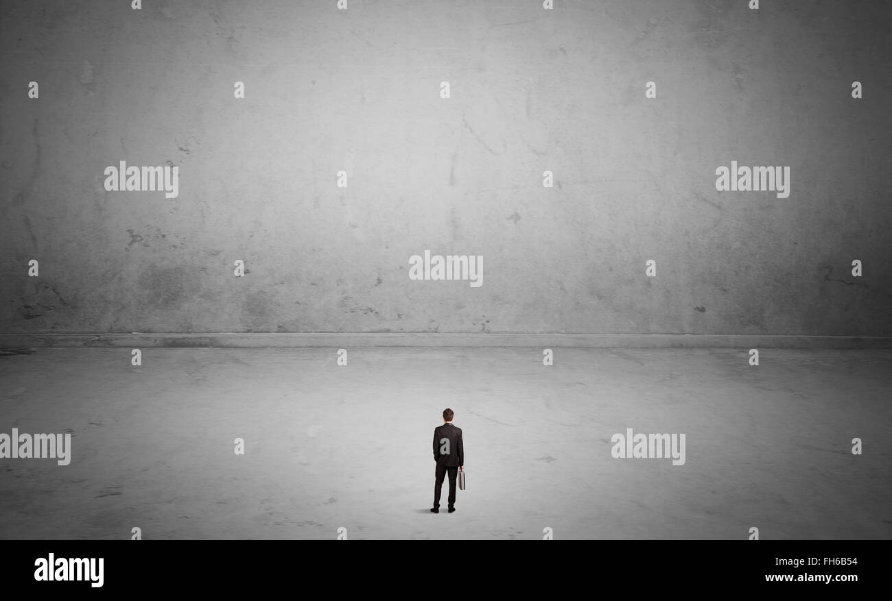 Small business person in large empty space Stock Photo - Alamy