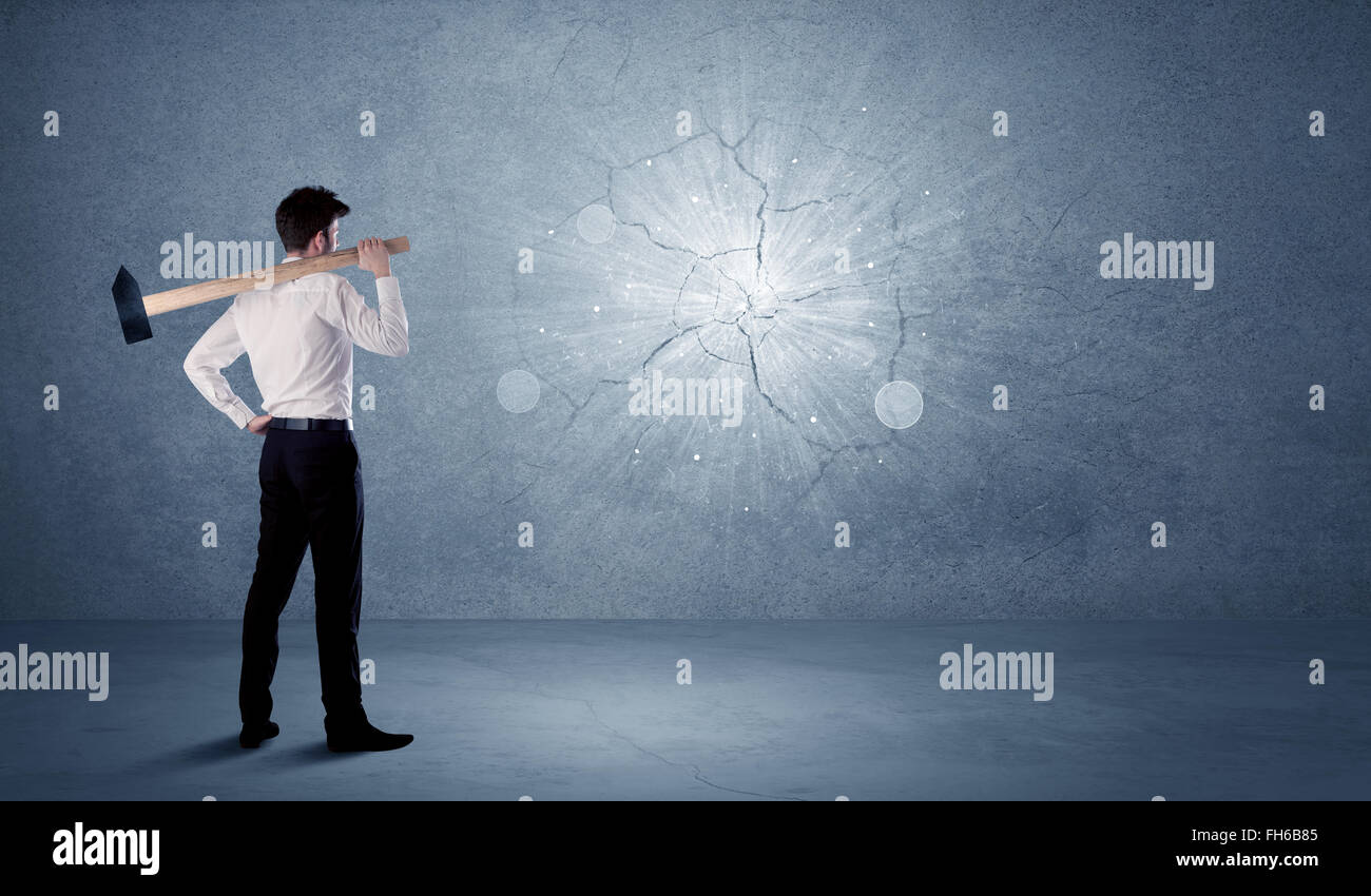 Business man hitting wall with a hammer Stock Photo - Alamy
