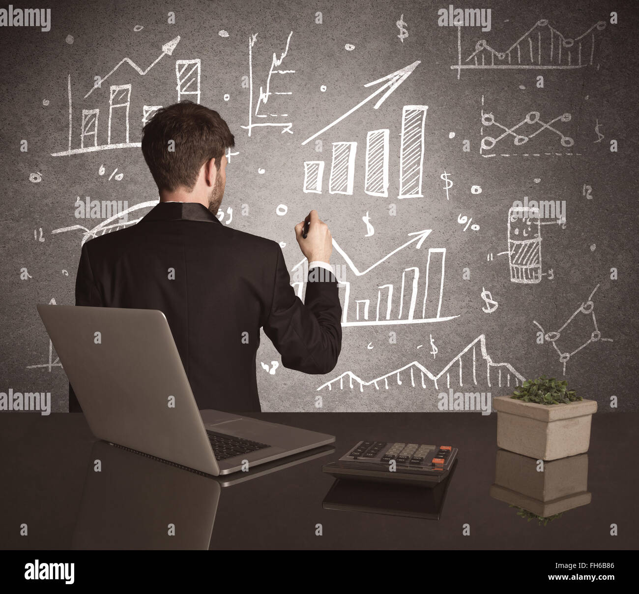 Businessman drawing sales charts on wall Stock Photo - Alamy