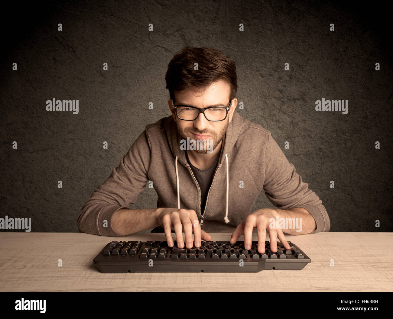Computer geek typing on keyboard Stock Photo - Alamy