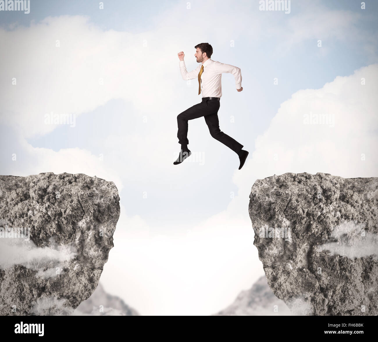 Business man jump dangerous mountain hi-res stock photography and ...