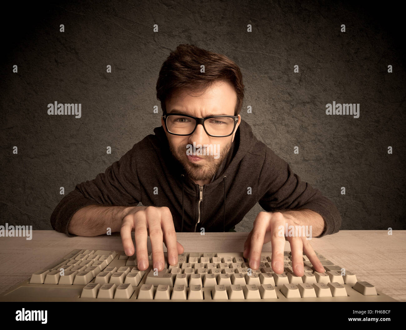 Computer geek typing on keyboard Stock Photo - Alamy