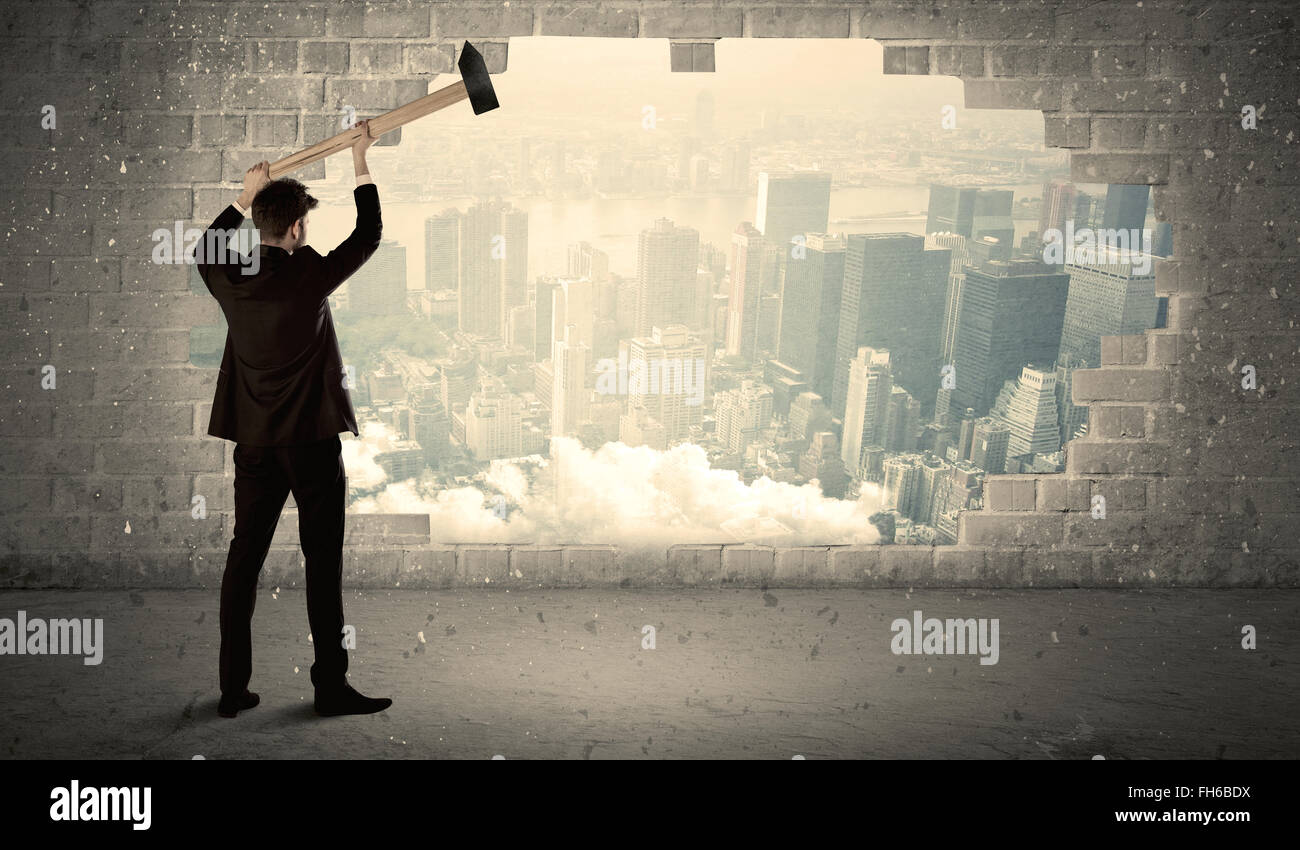 Business man hitting wall with hammer on city view Stock Photo - Alamy