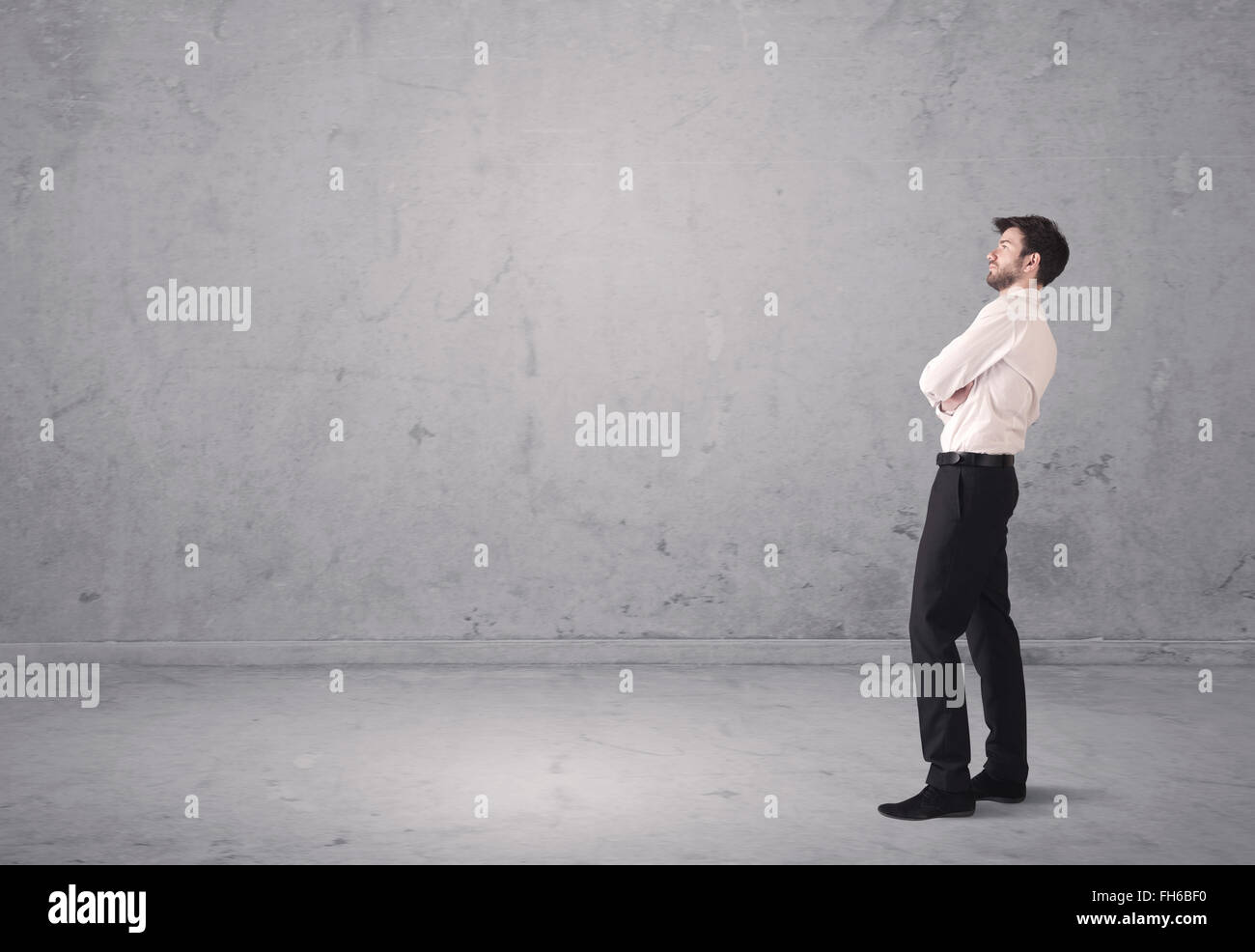 Young businessman standing confused Stock Photo - Alamy