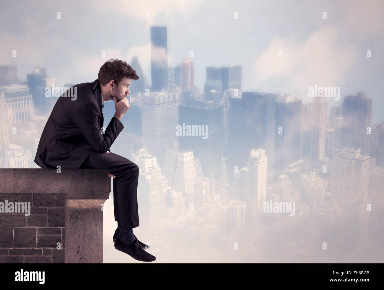 Sales person sitting on top of a tall building Stock Photo - Alamy