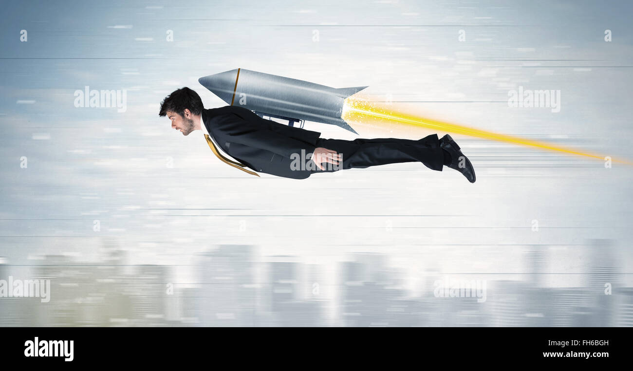 Superhero business man flying with jet pack rocket above the city Stock ...