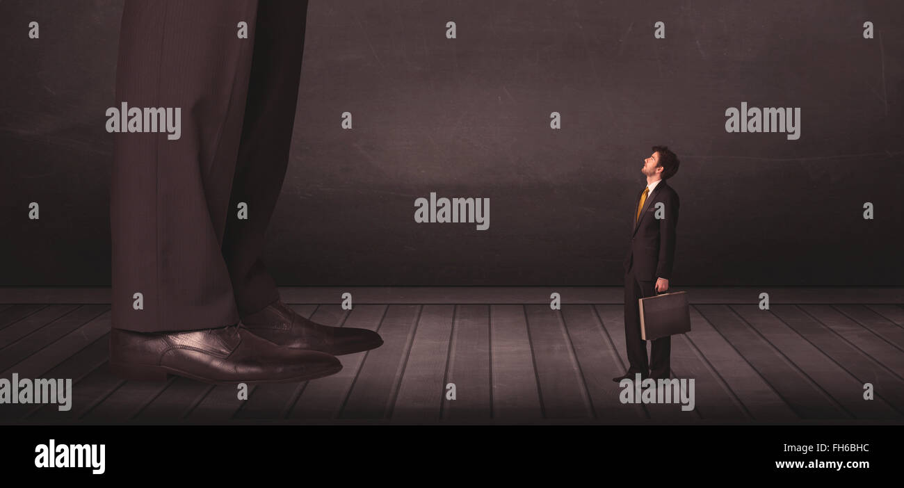 Big person with small businessman concept Stock Photo - Alamy