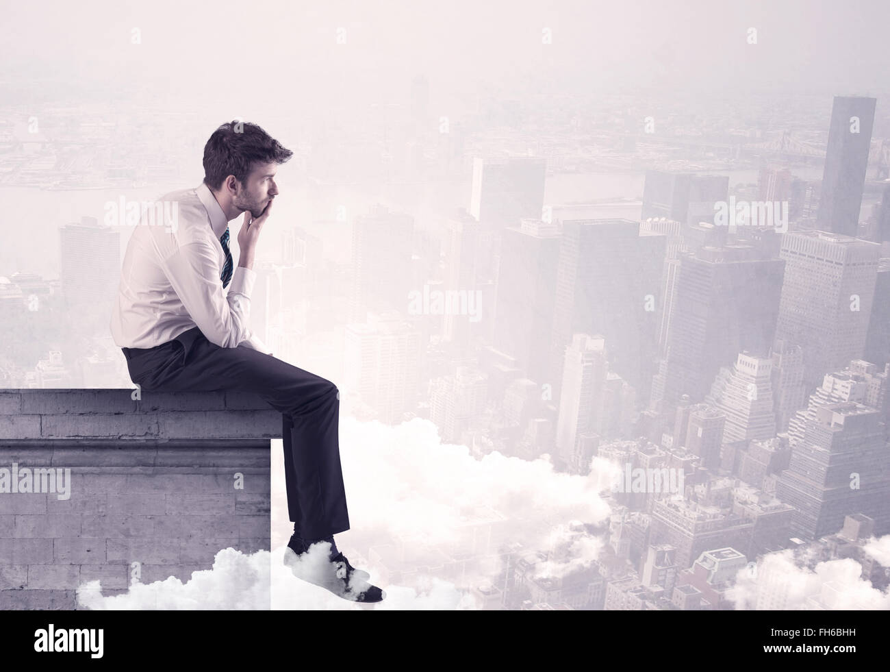 Sales person sitting on building edge in city Stock Photo - Alamy