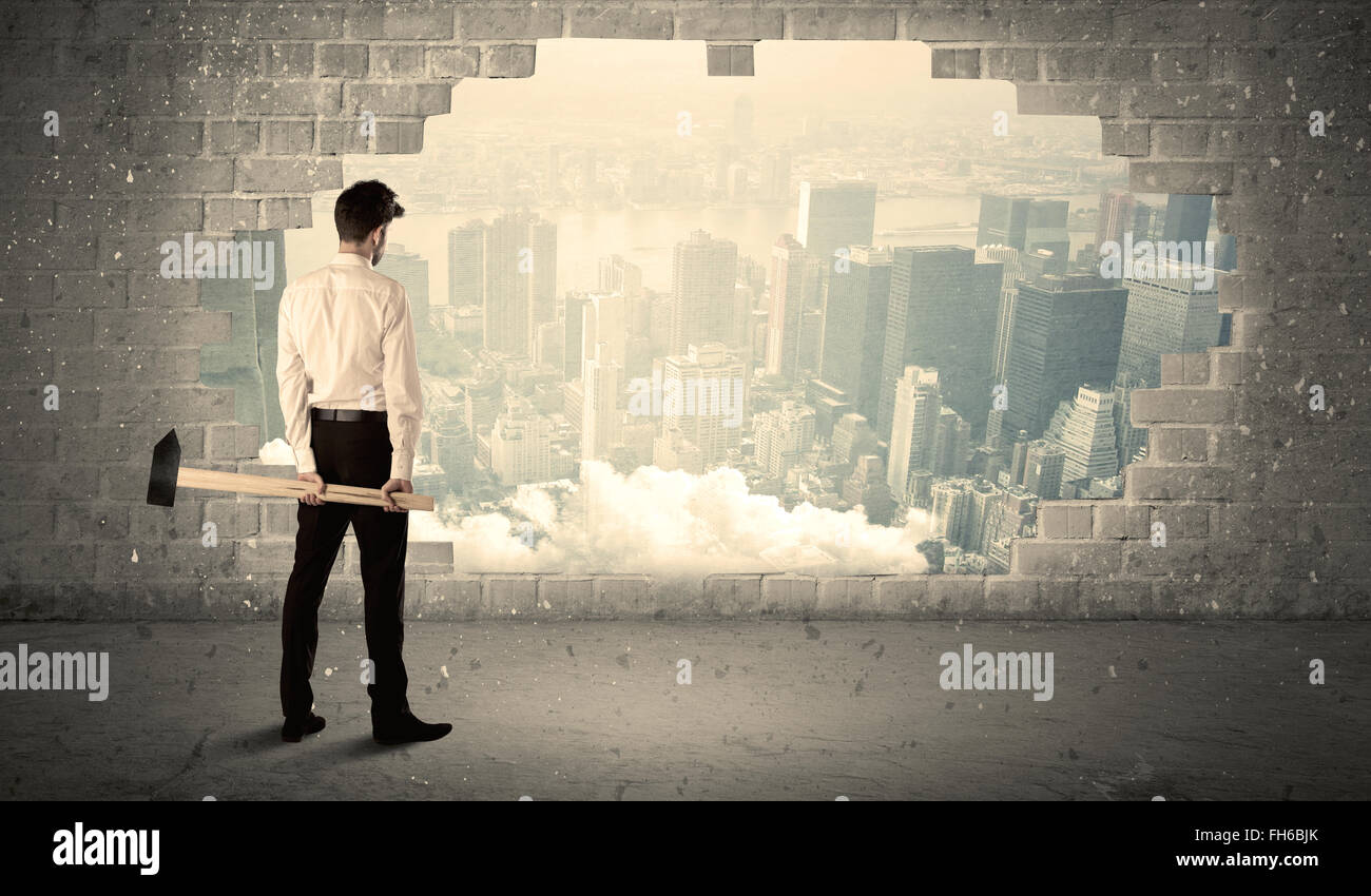 Business man hitting wall with hammer on city view Stock Photo - Alamy