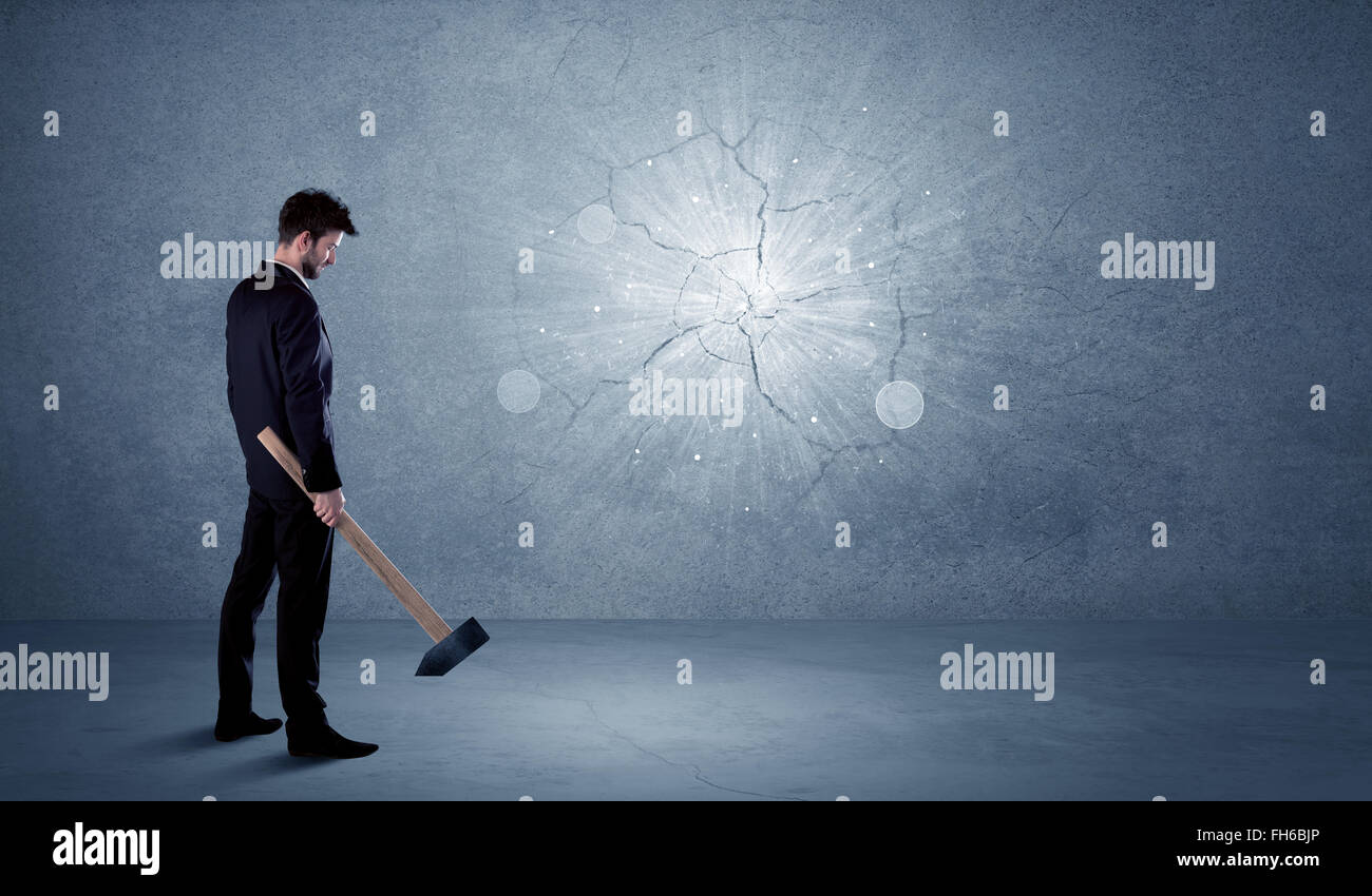 Business man hitting wall with a hammer Stock Photo - Alamy