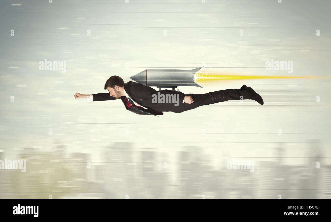 Superhero business man flying with jet pack rocket above the city Stock ...