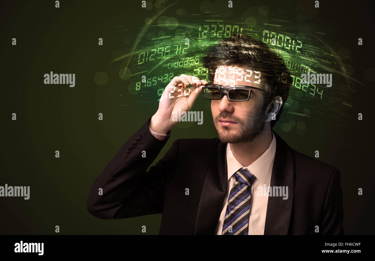 Business man looking at high tech number calculations Stock Photo - Alamy