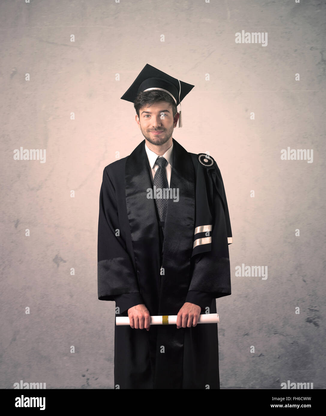 Portrait of a young graduate student on grungy background Stock Photo ...