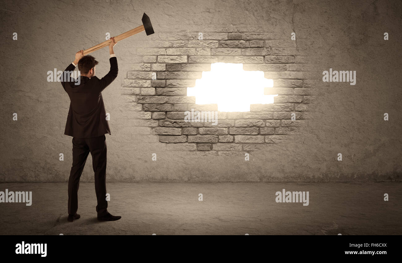 Business man hitting brick wall with hammer and opening a hole Stock ...