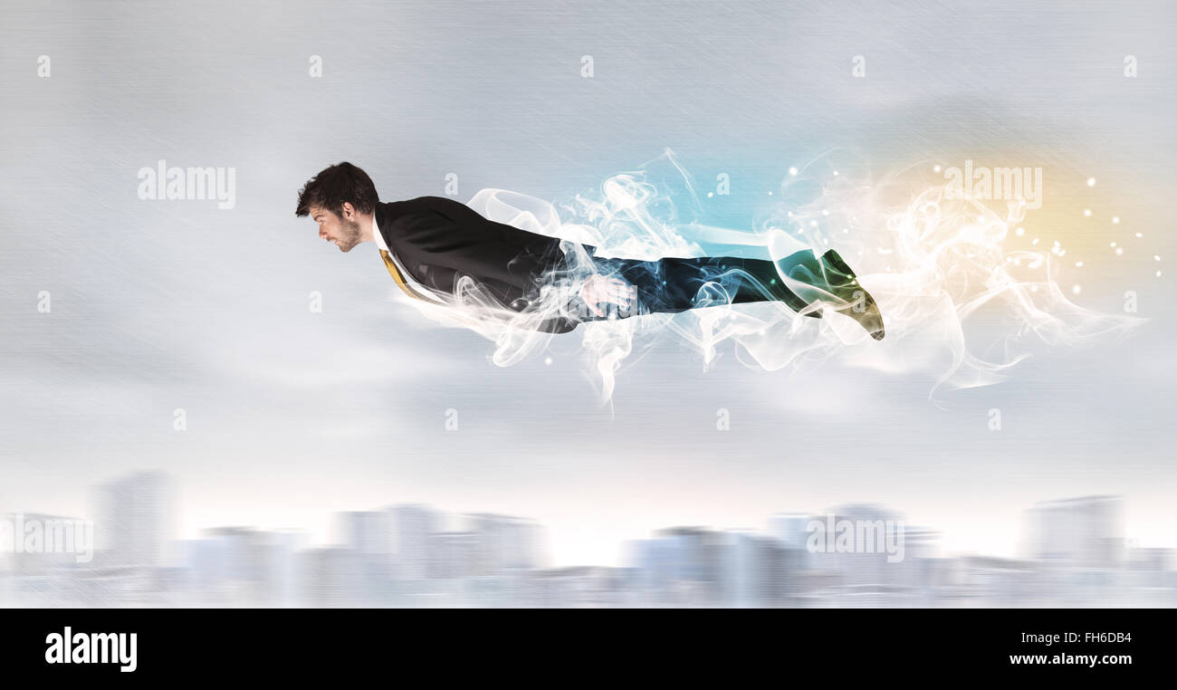 Hero superman flying above city with smoke left behind Stock Photo - Alamy