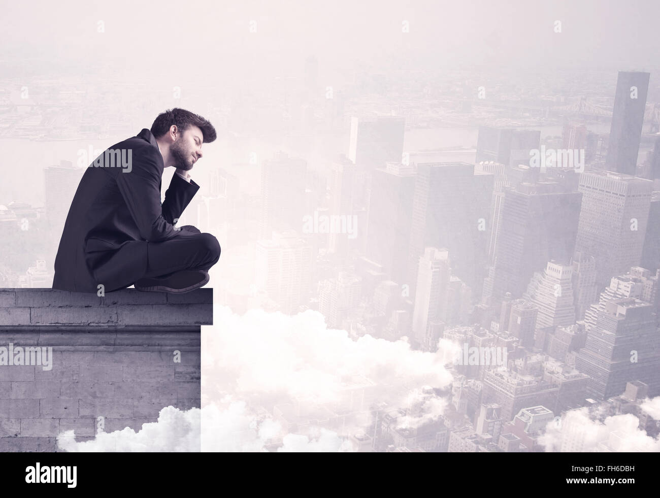 Sales person sitting on building edge in city Stock Photo - Alamy