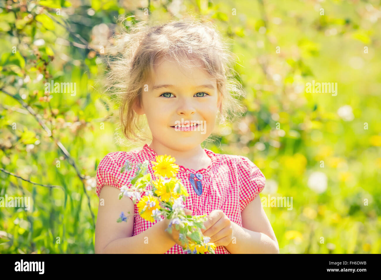 Happy little girl in spring sunny park Stock Photo - Alamy
