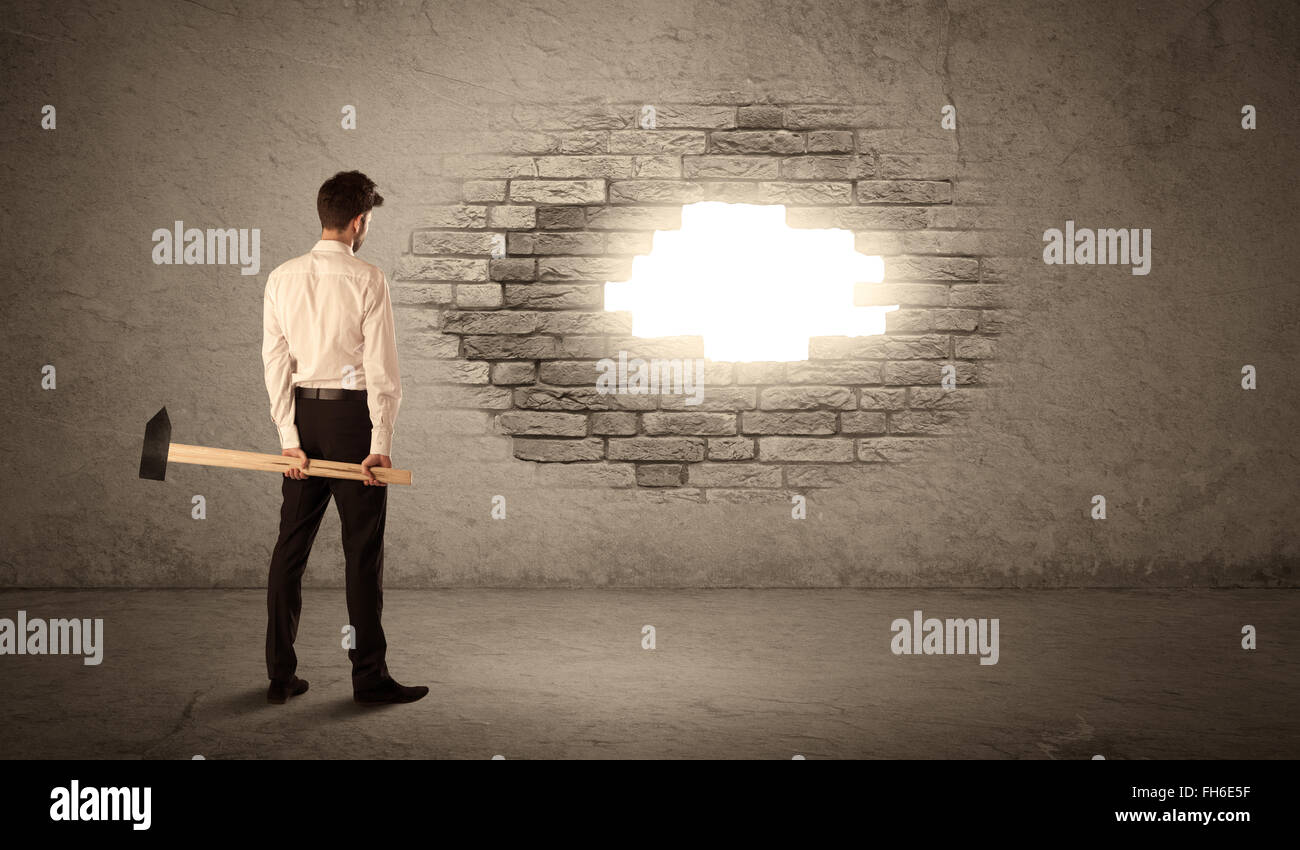 Business man hitting brick wall with hammer and opening a hole Stock ...