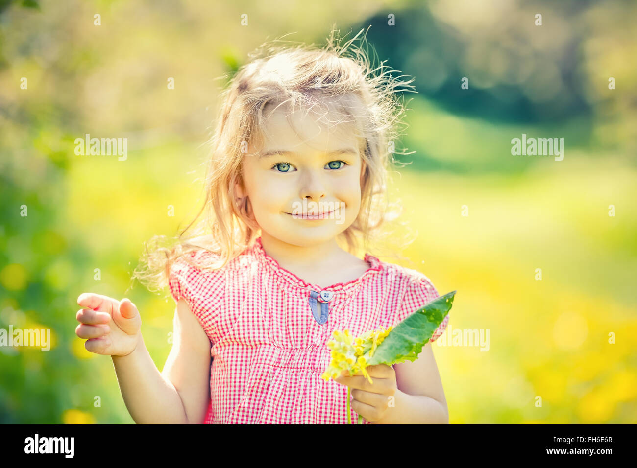 Happy little girl in spring sunny park Stock Photo - Alamy