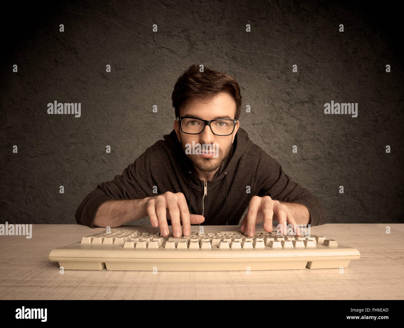 Computer geek typing on keyboard Stock Photo - Alamy