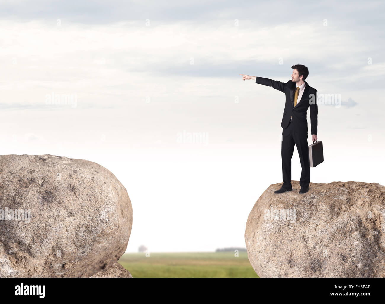 Businessman standing on rock hi-res stock photography and images - Alamy