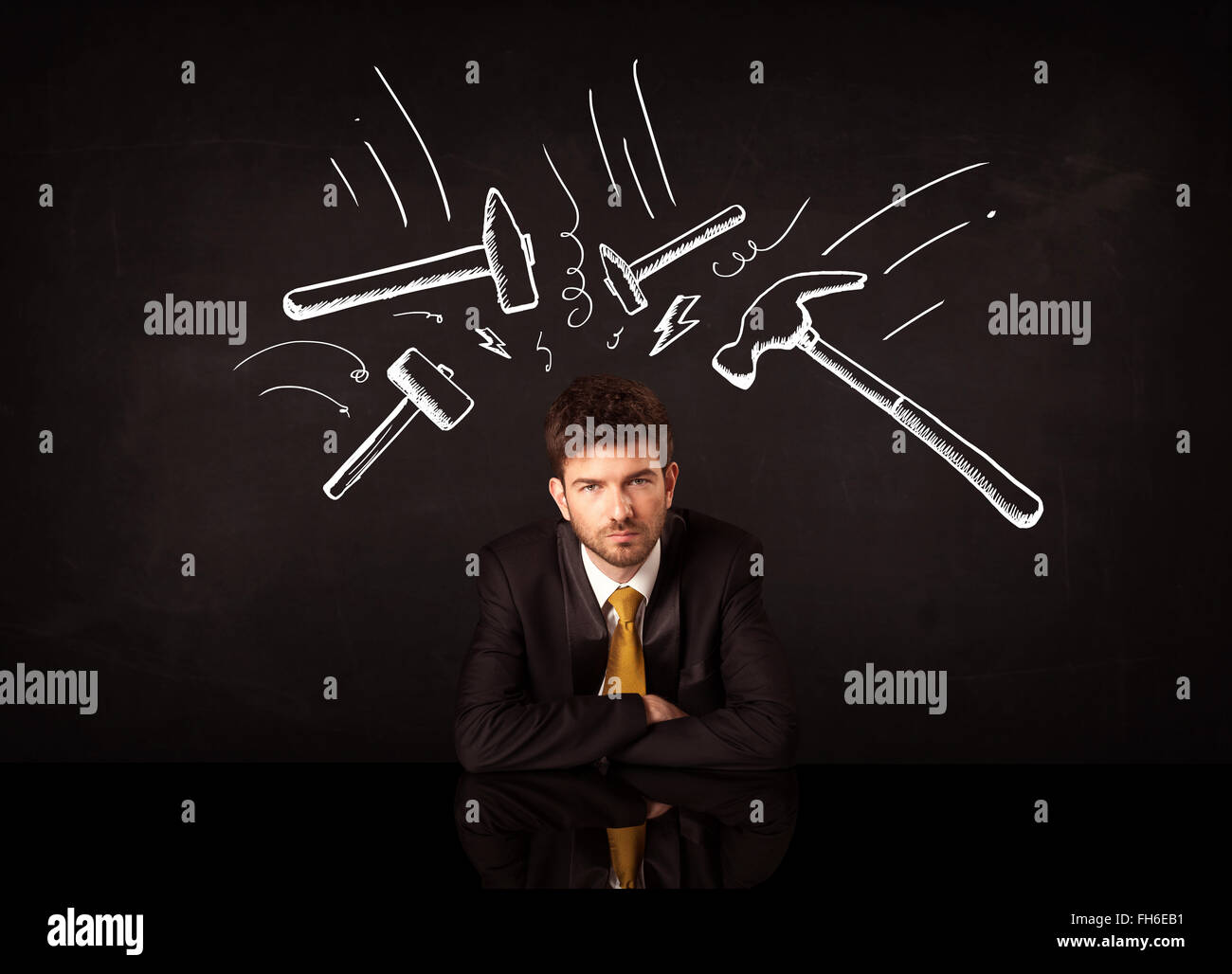 Depressed businessman sitting under hammer marks Stock Photo - Alamy
