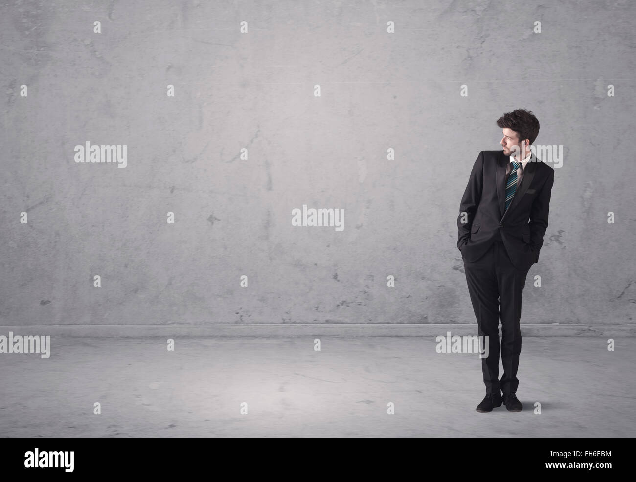 Young businessman standing confused Stock Photo - Alamy