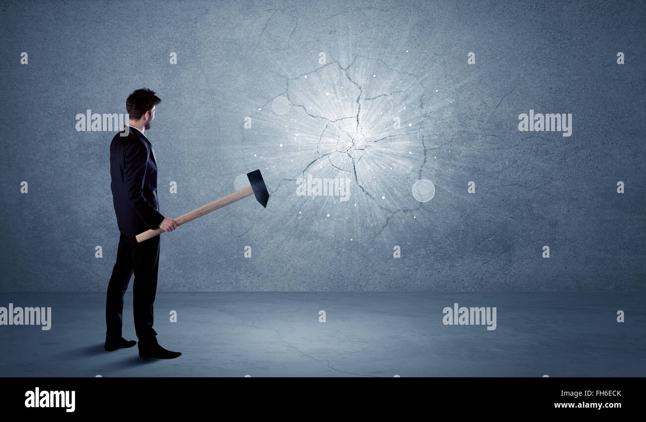 Business man hitting wall with a hammer Stock Photo - Alamy