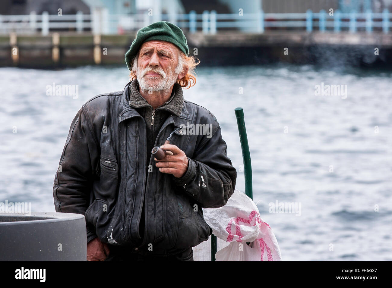 An man puffs on his pipe by the Bosphorus in Istanbul, Turkey Stock ...