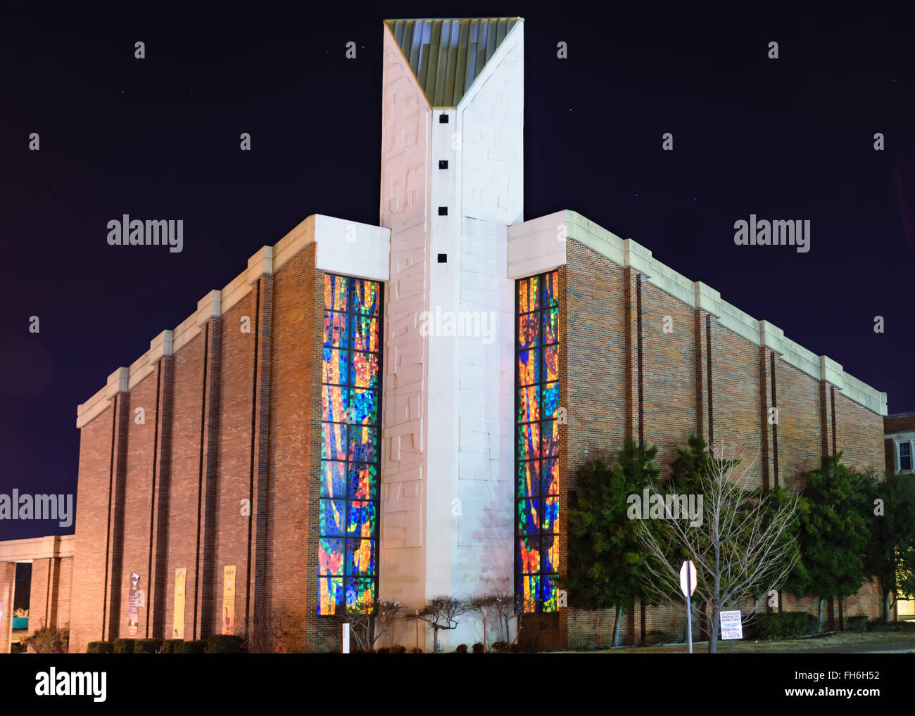Church exterior with illuminated stained glass in Muskogee, Oklahoma ...