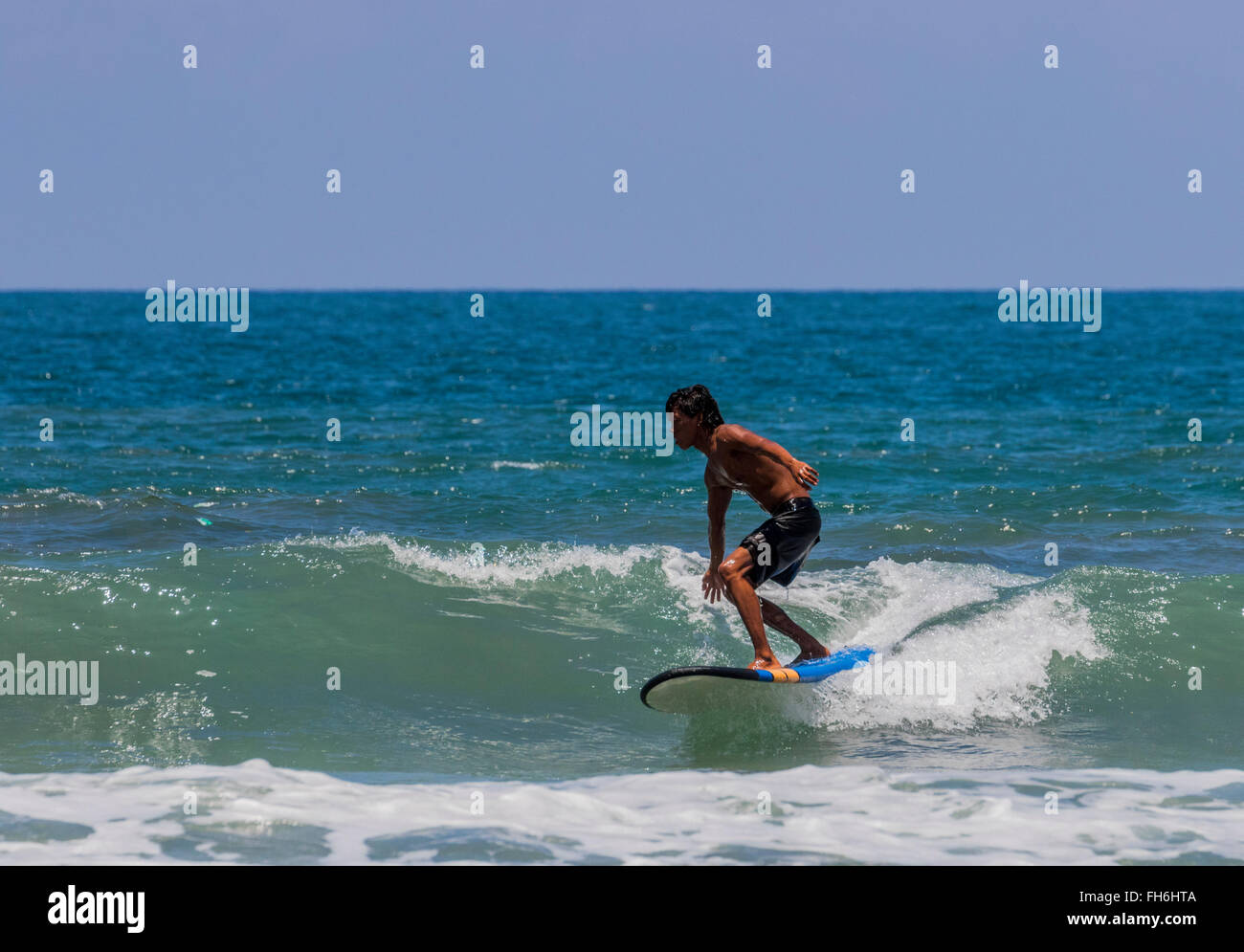 man enjoying surf boarding on Kuta beach Bali Indonesia Stock Photo - Alamy