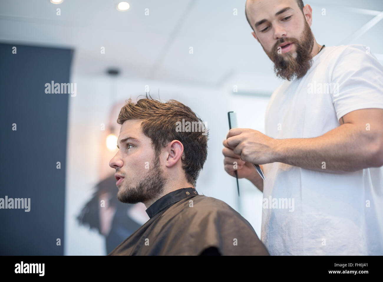 Young man at barber's shop Stock Photo - Alamy
