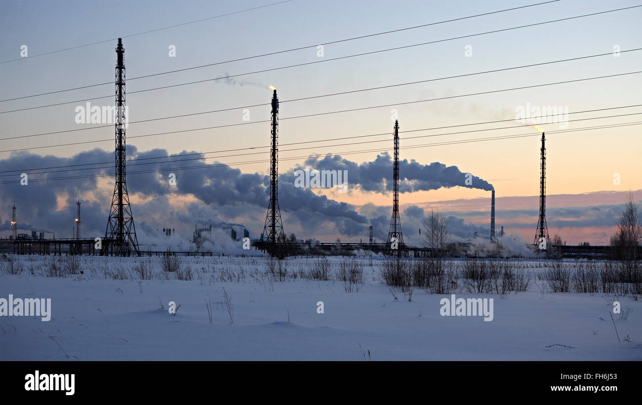 Refinery at sunset sky background. Frosty snowy winter evening Stock ...
