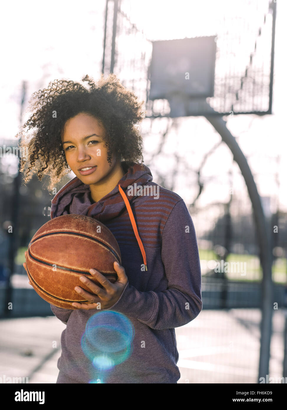 Portrait of young woman with basketball at backlight Stock Photo - Alamy