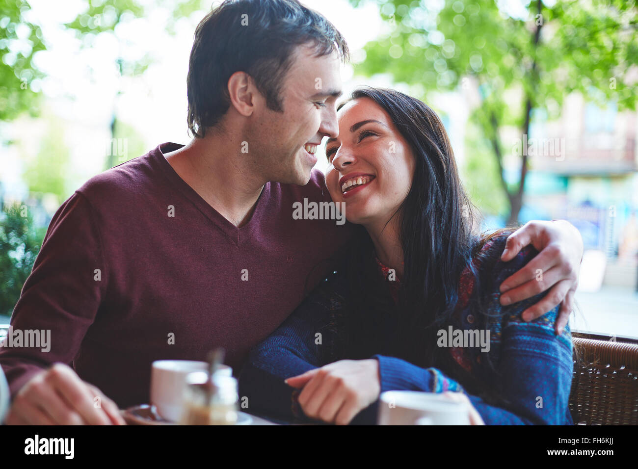 Happy young dates relaxing in cafe Stock Photo - Alamy