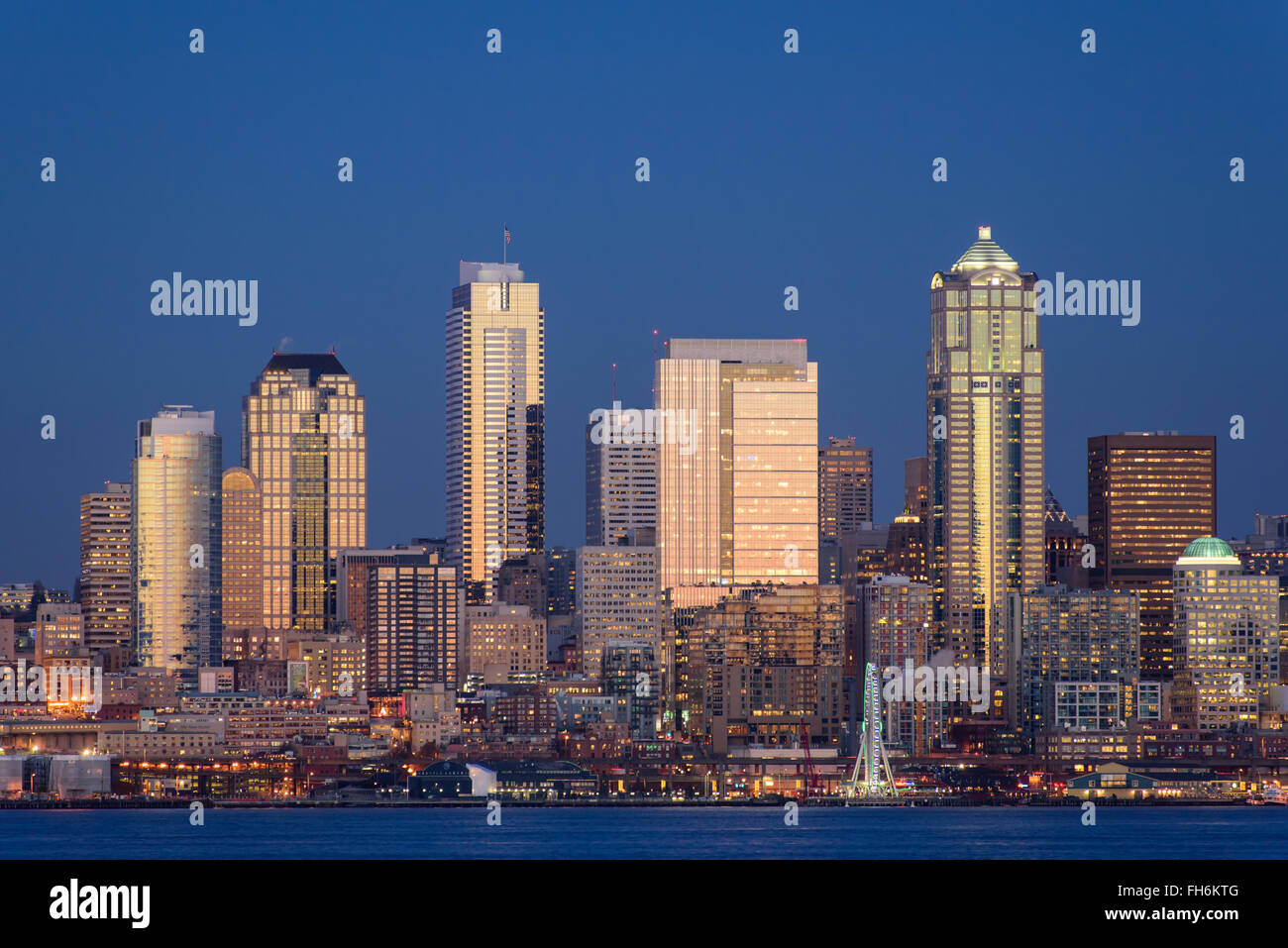 Seattle evening skyline illuminated by setting sun at blue hour with ...