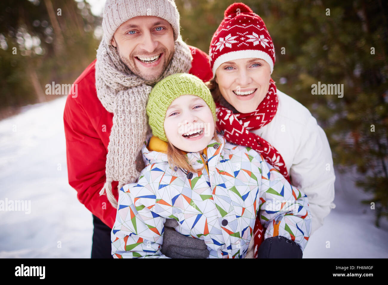 Happy family looking at camera and laughing Stock Photo - Alamy