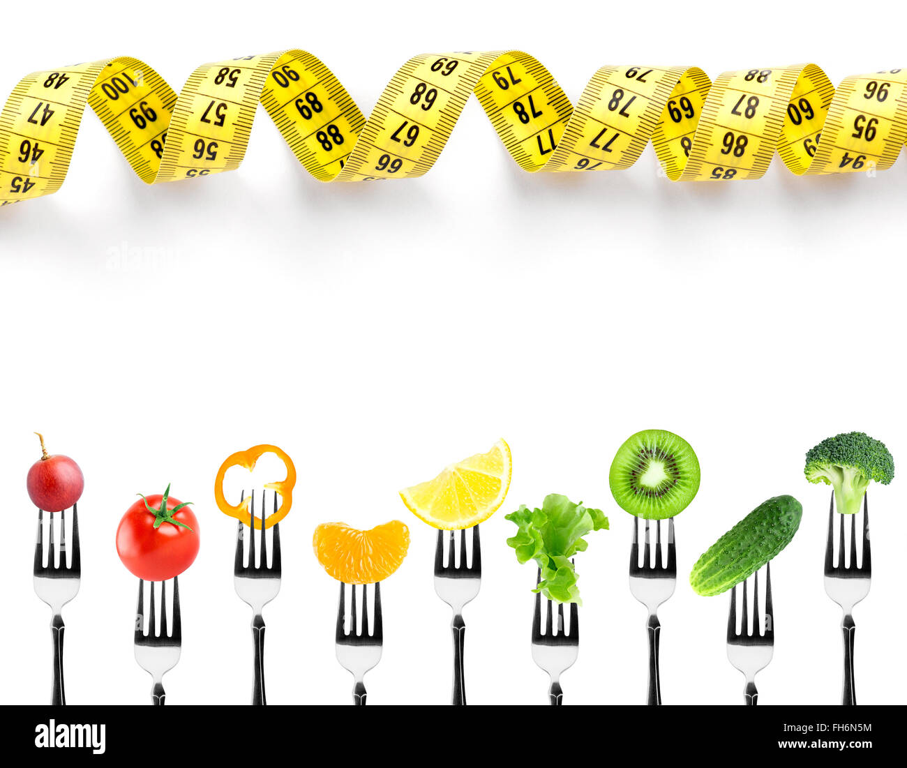 Fruits and vegetables on fork with measuring tape on white background ...