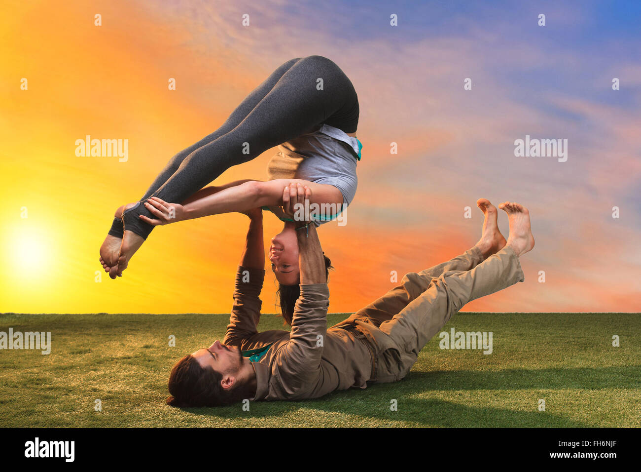 The two people doing yoga exercises Stock Photo - Alamy