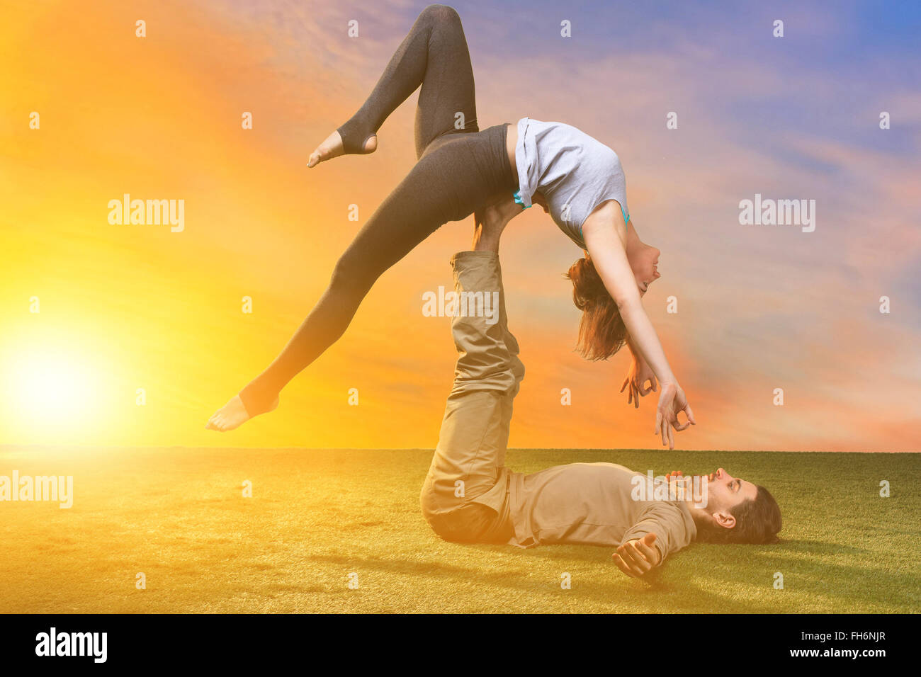 The two people doing yoga exercises Stock Photo - Alamy