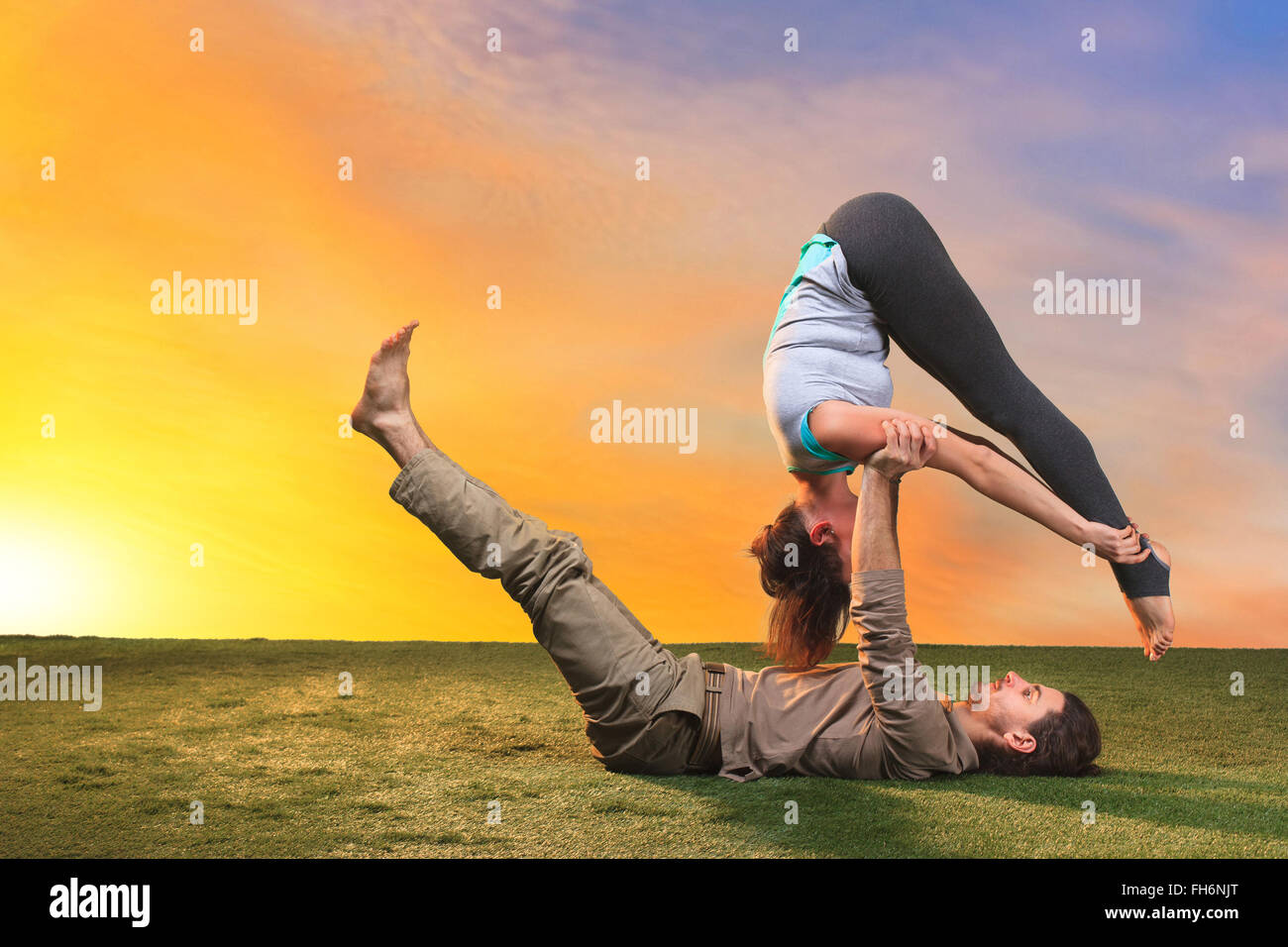 The two people doing yoga exercises Stock Photo - Alamy