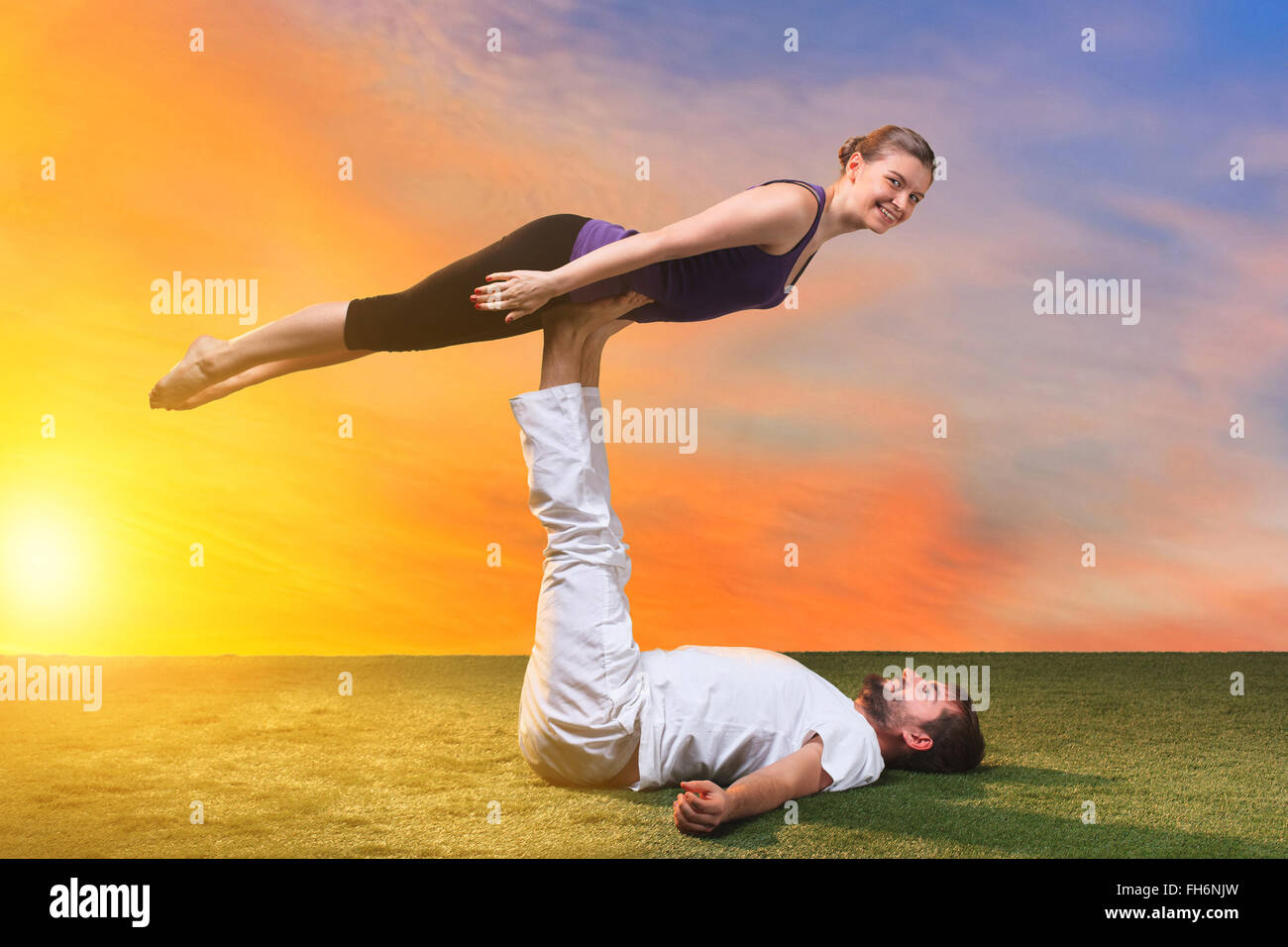 The two people doing yoga exercises Stock Photo - Alamy