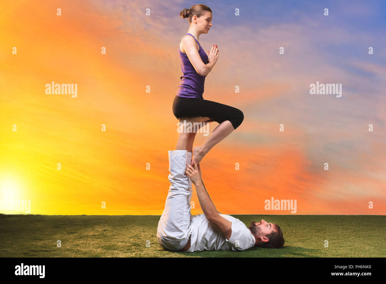 The two people doing yoga exercises Stock Photo - Alamy