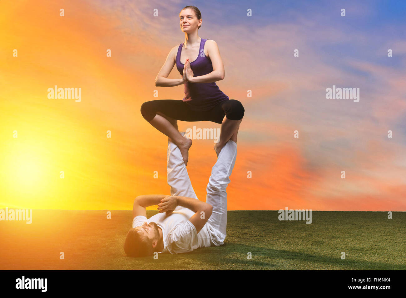 The two people doing yoga exercises Stock Photo - Alamy