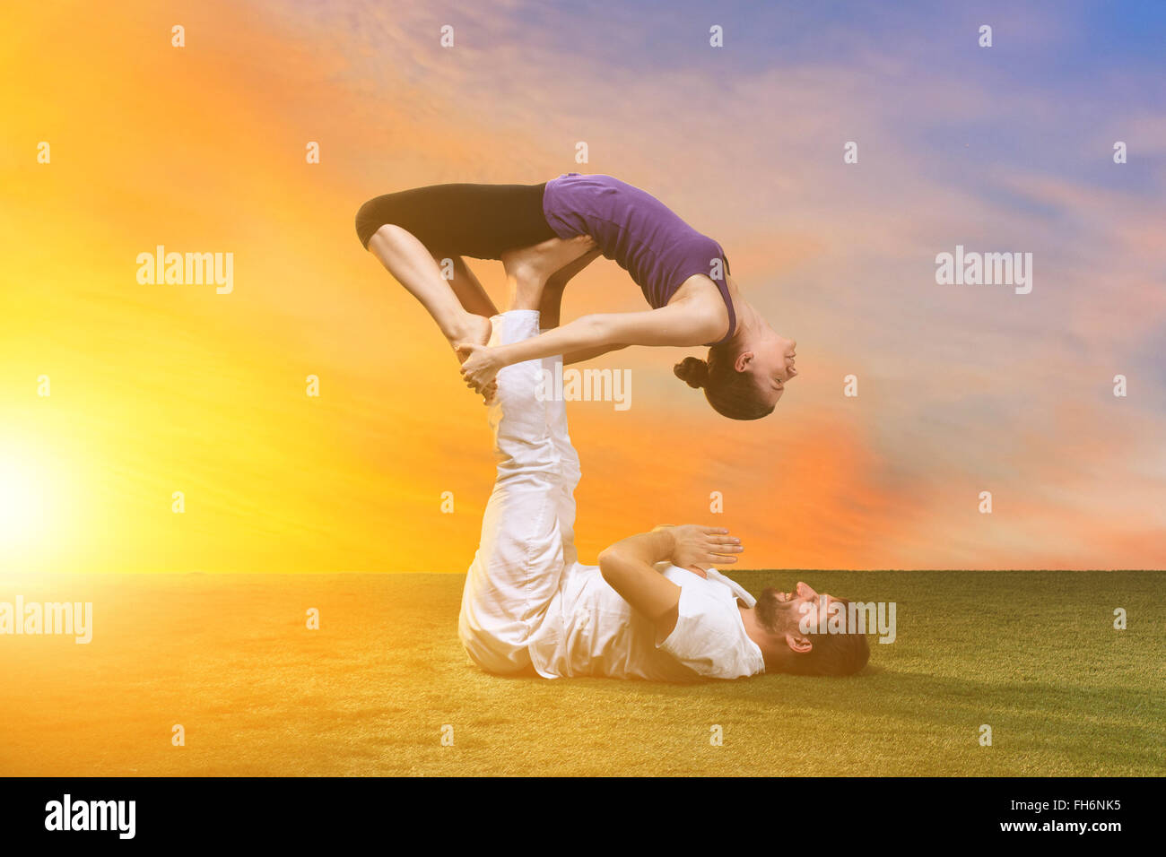 The two people doing yoga exercises Stock Photo - Alamy